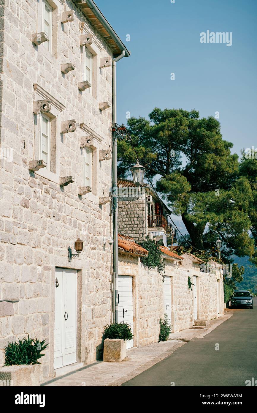 Ancient stone house by the road with shutter holders near the windows ...