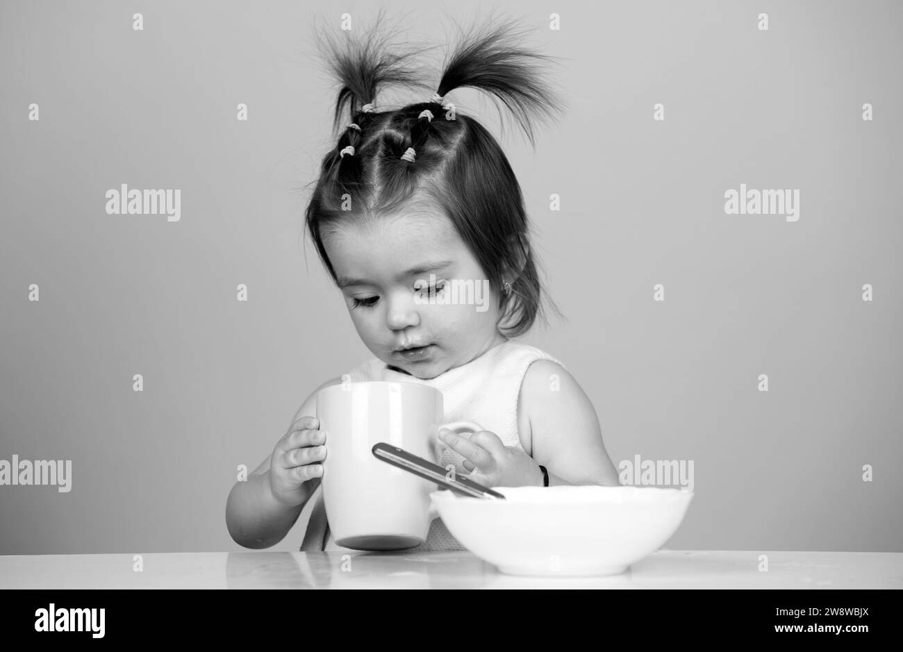 Child eats on own Black and White Stock Photos & Images - Alamy