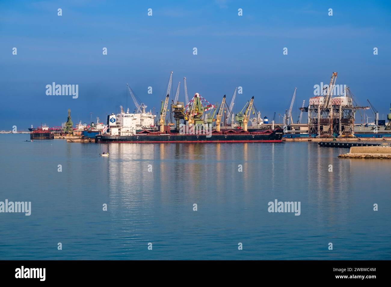 Cargo ships and unloading cranes in the Taranto's industrial port Stock ...
