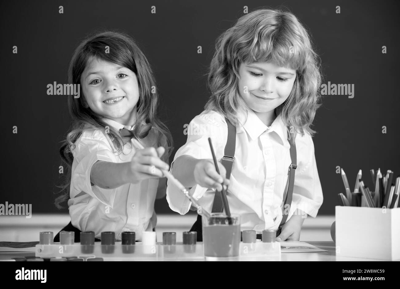 Cute school friends kids drawing and painting at school. Friendly boy ...