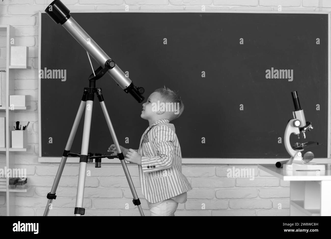 School boy with telescope learning astronomy lesson at school Stock ...