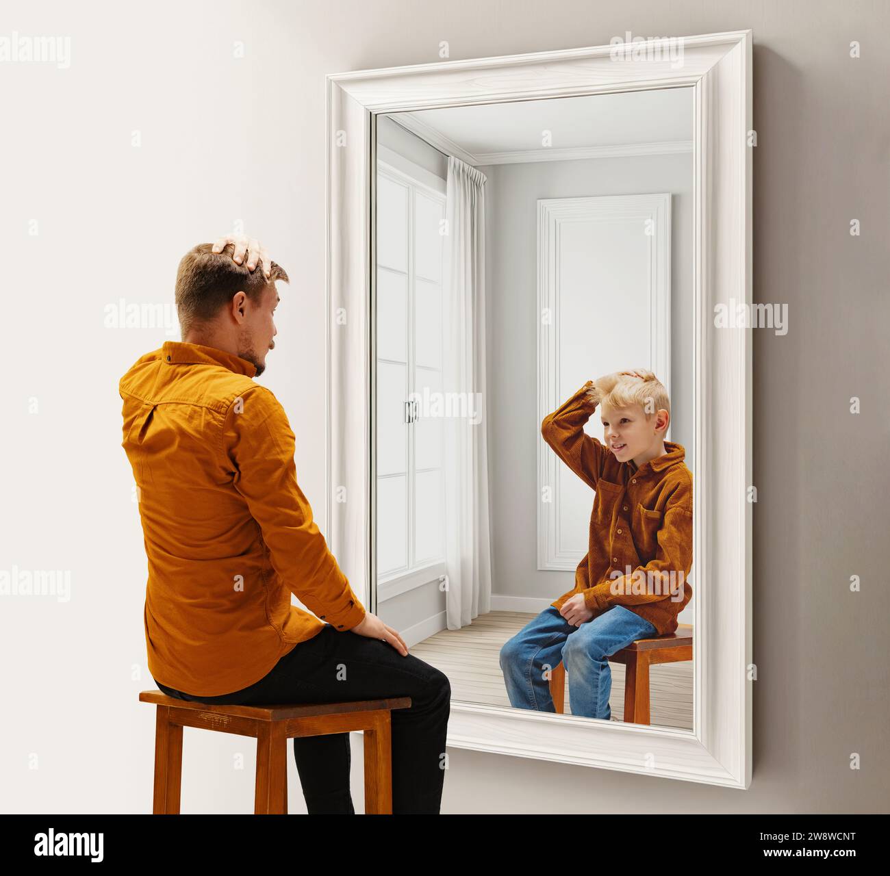 Man in his 30s sitting and looking in mirror with reflection his ...