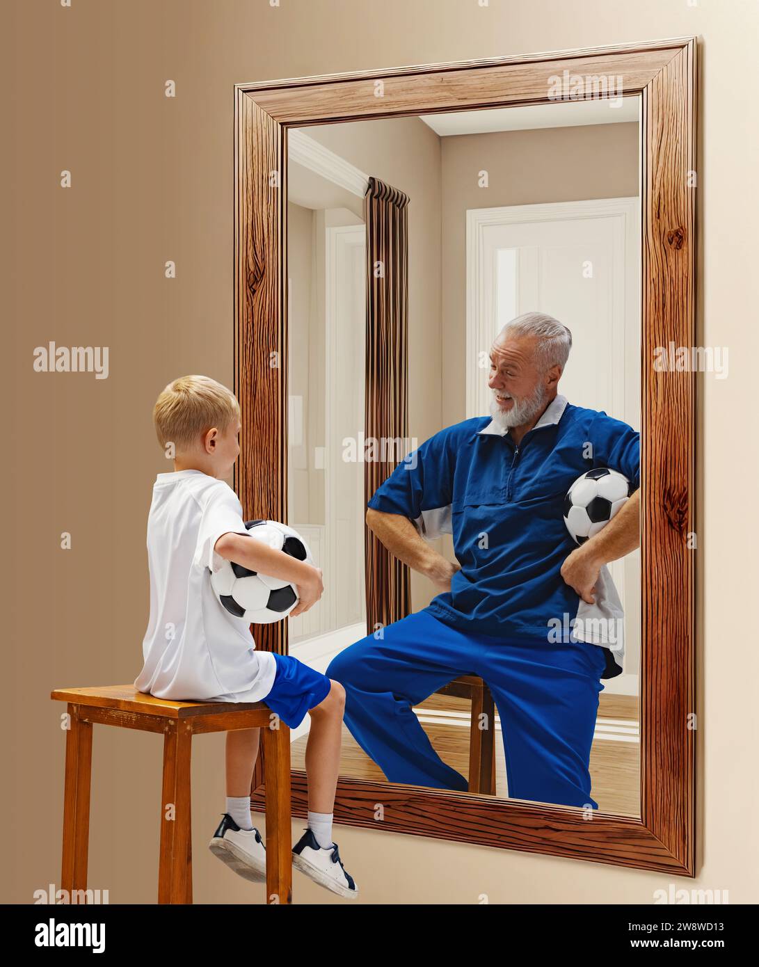 Little boy, child with football ball sitting and looking in mirror with ...