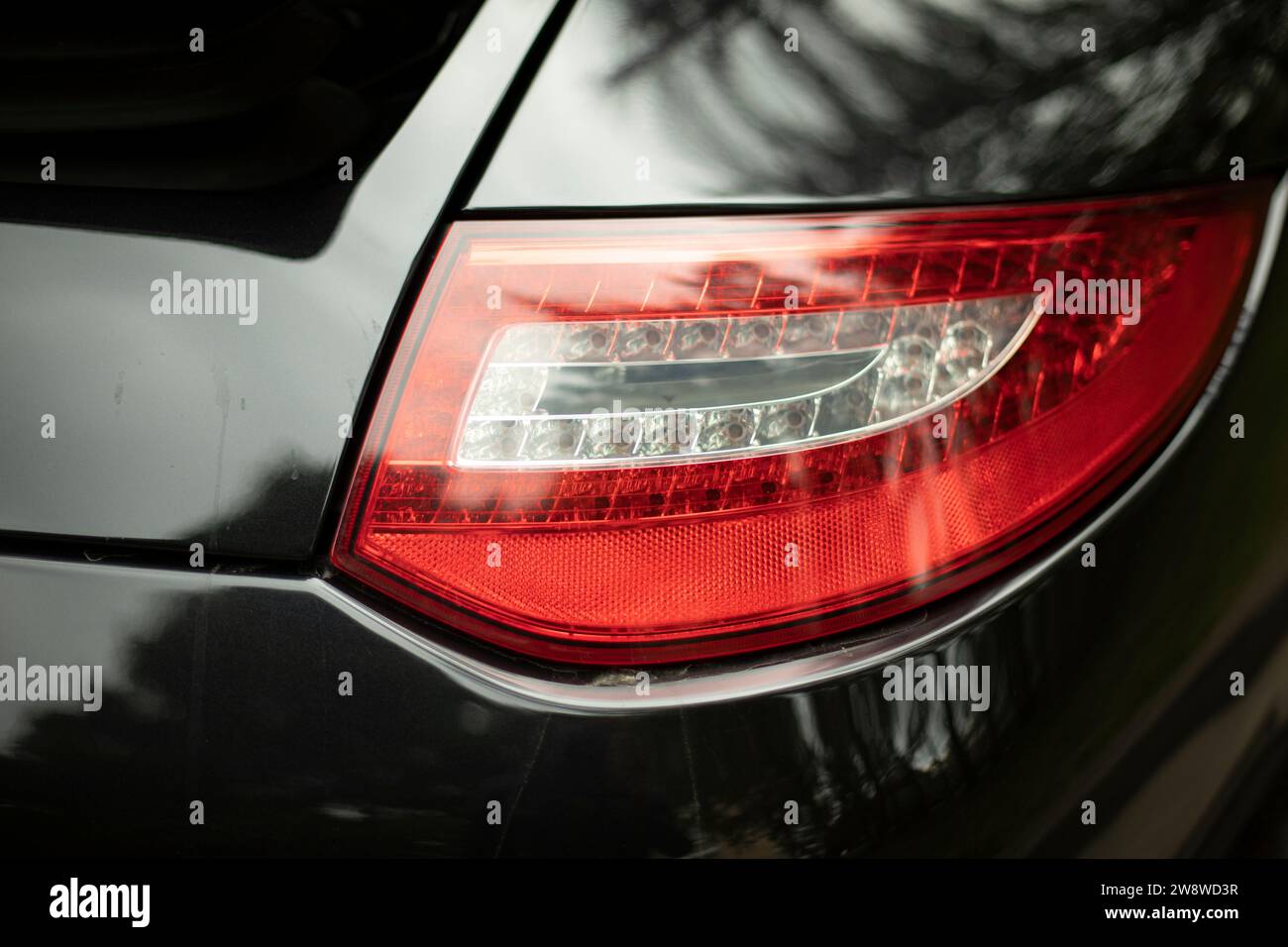 Car rear lamp. Brake light on car. Red headlight. Transport details ...
