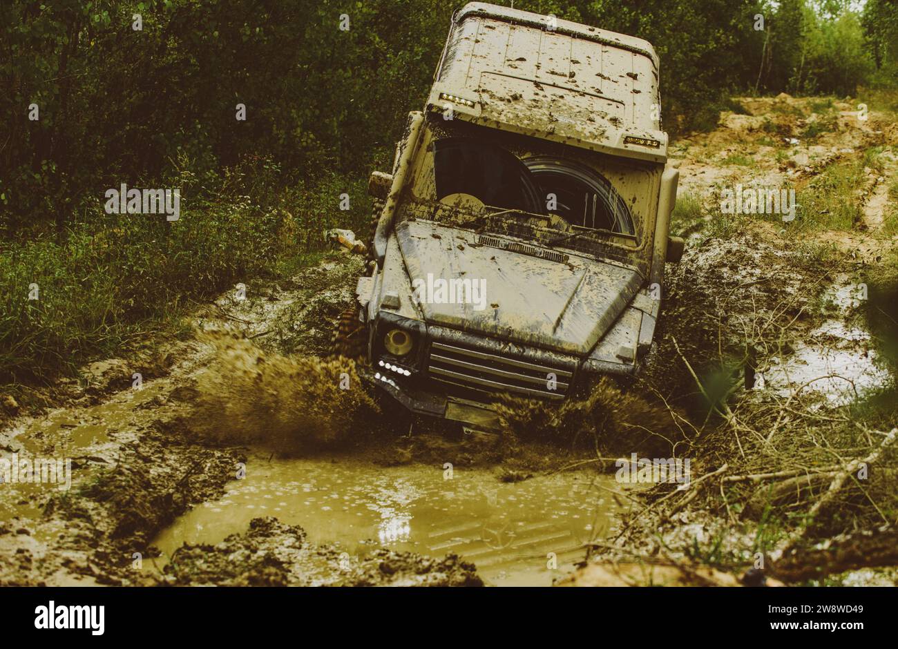 Mud and water splash in off the road racing. Tracks on a muddy field ...