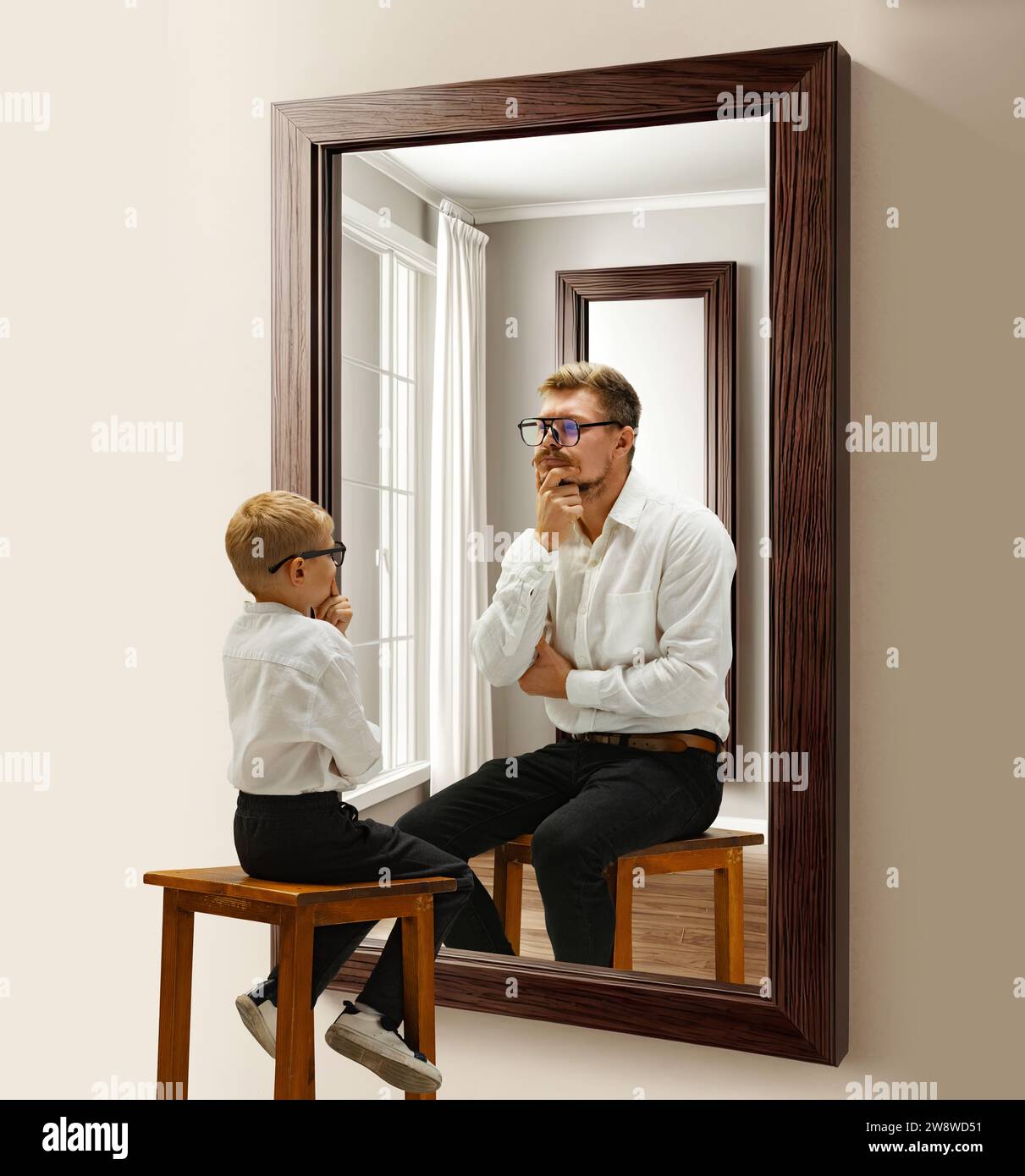 Little boy, child sitting near mirror and imagining him being adult man ...