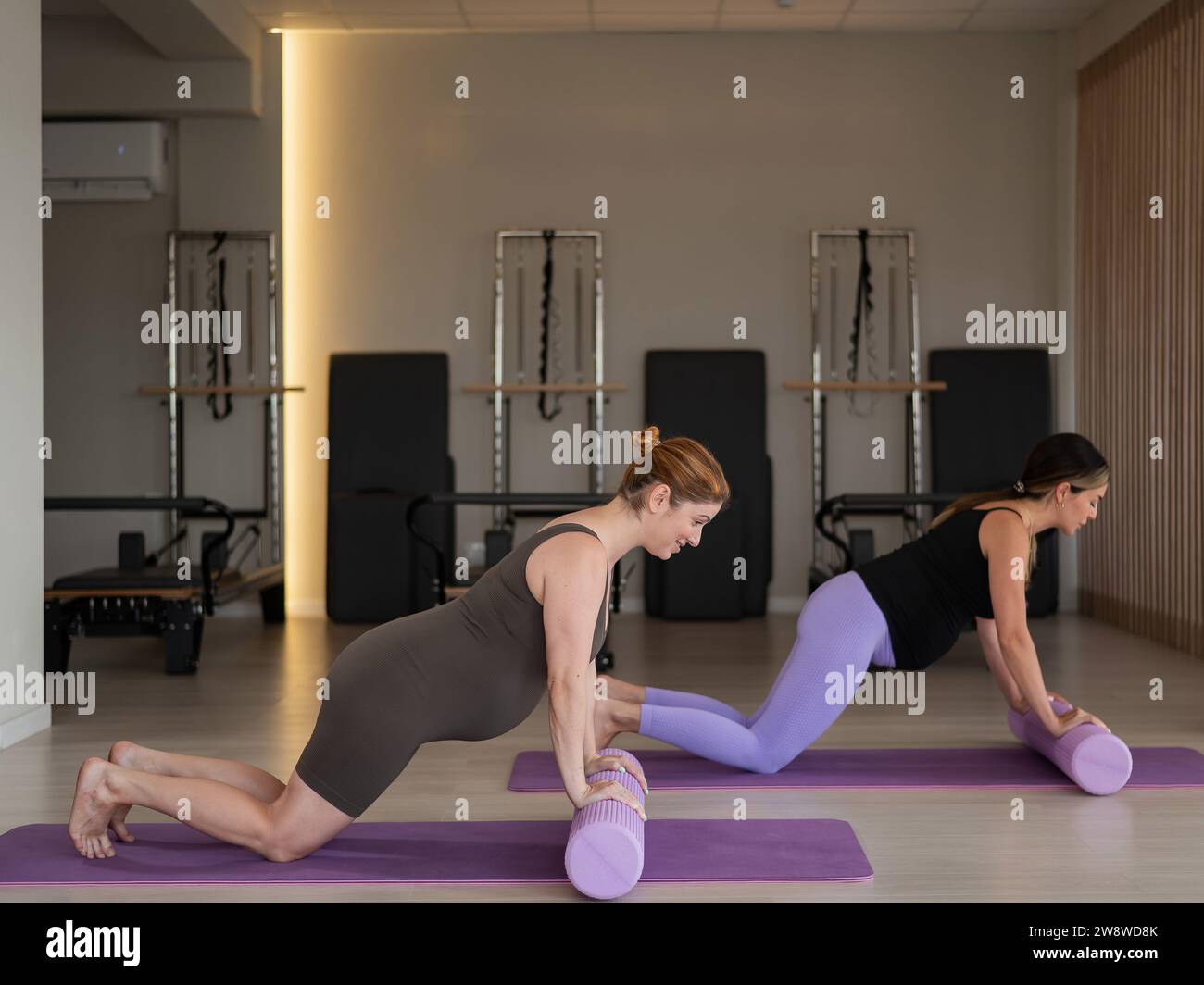 Two pregnant women do a plank with bolsters. Yoga for pregnant women ...
