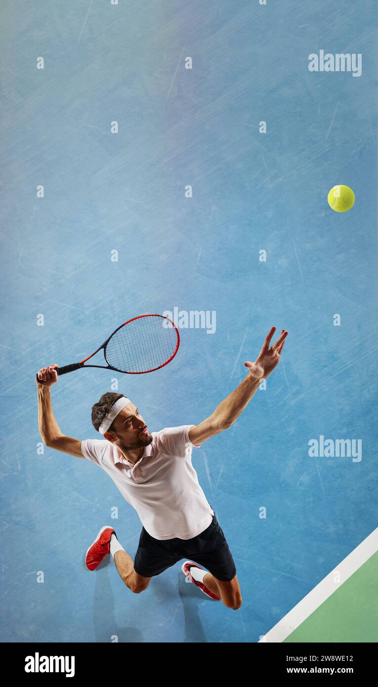 Top view image of young man,, tennis player in motion, hitting ball ...