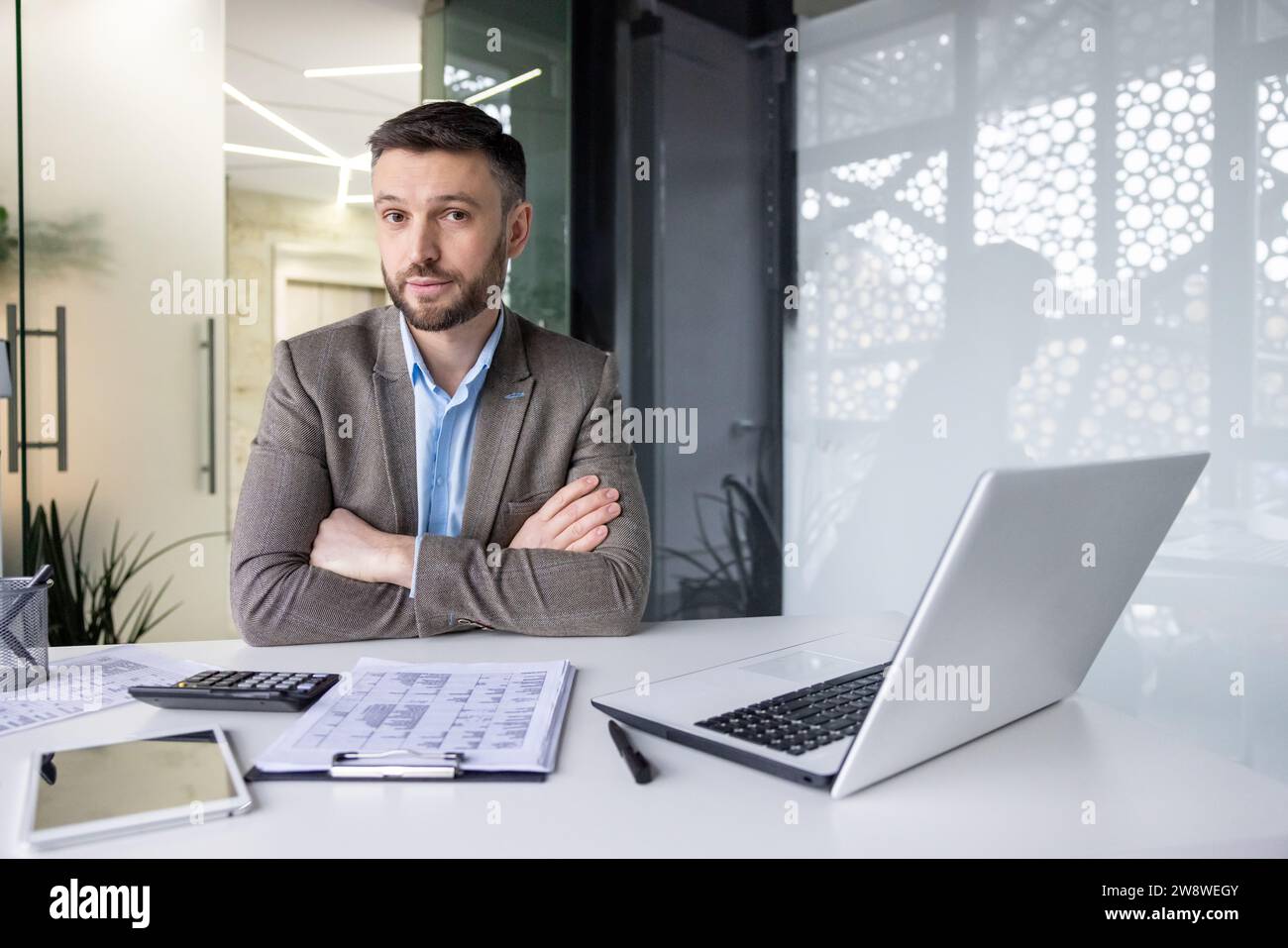 Serious and focused financier accountant on paper work inside office ...