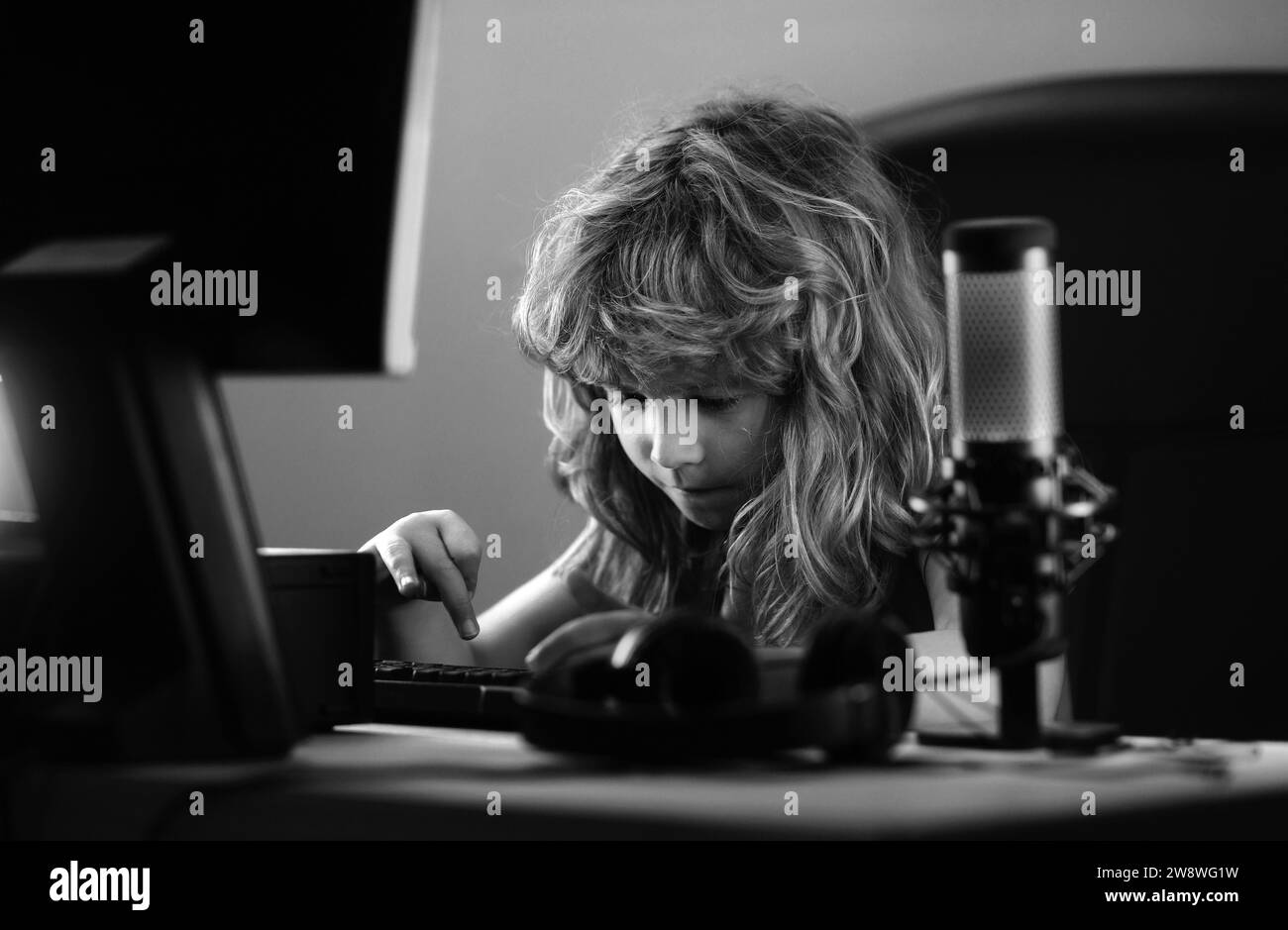 Little child gamer play computer game on desktop. Gaming stream and ...