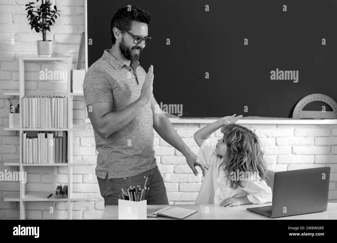 Teacher pupil boy in Black and White Stock Photos & Images - Alamy