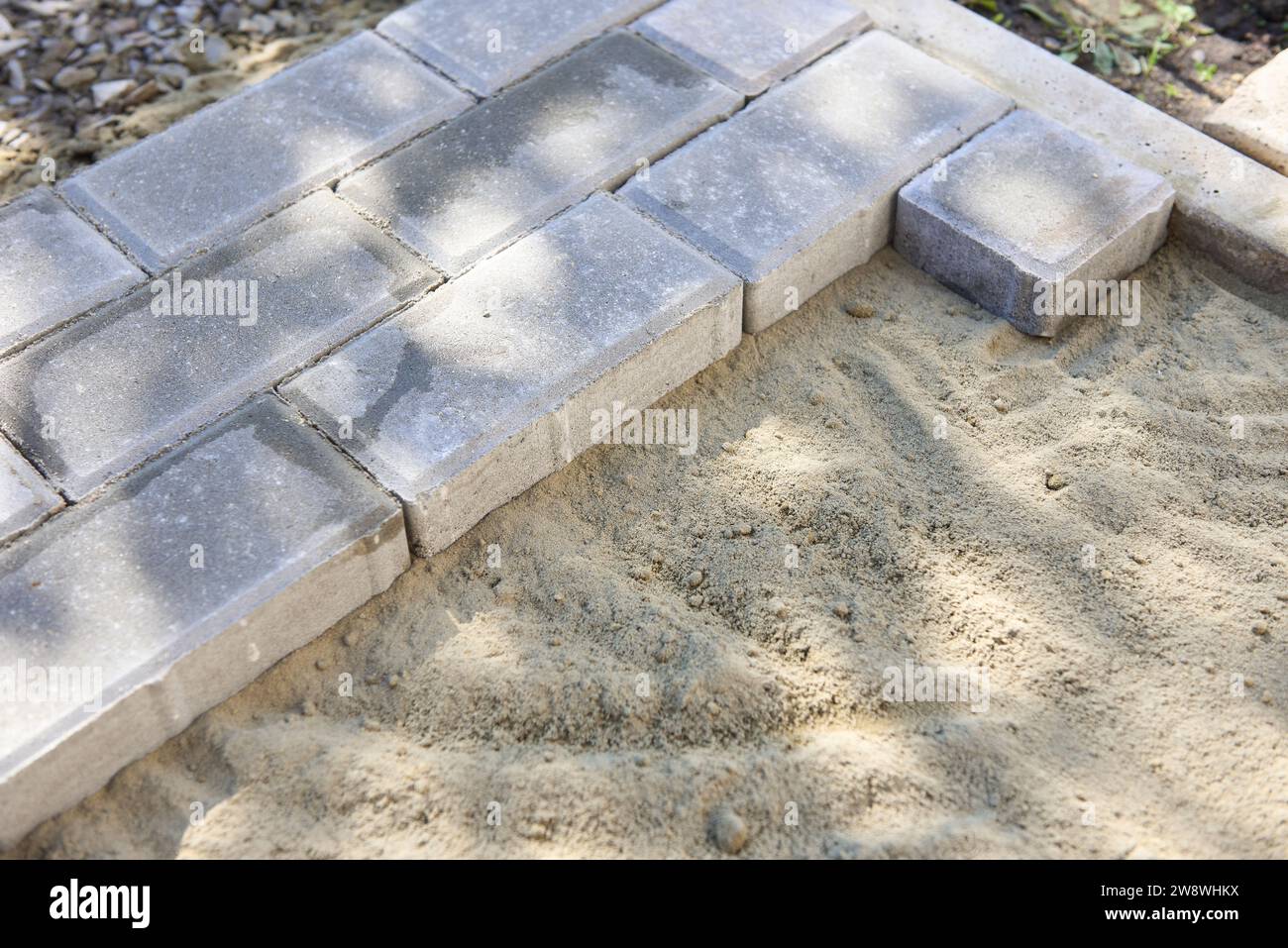 Laying paving slabs at a construction site Stock Photo - Alamy