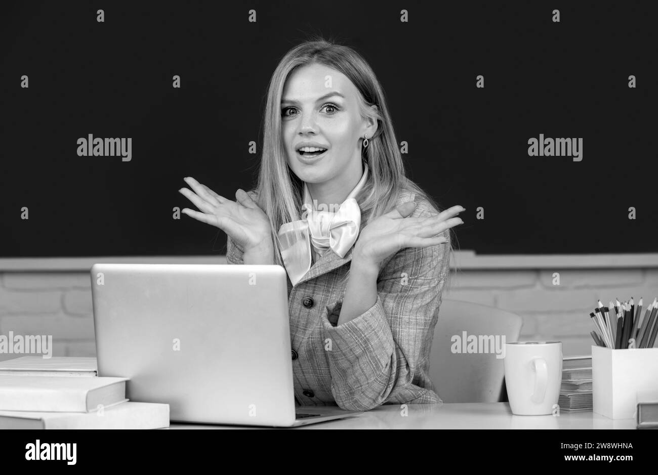 Excited student preparing exam and learning lessons in school classroom ...
