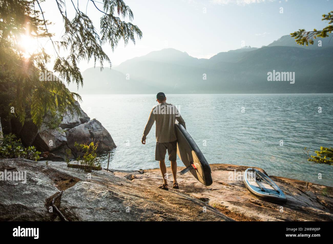 Preparing for paddle boarding hi-res stock photography and images - Alamy