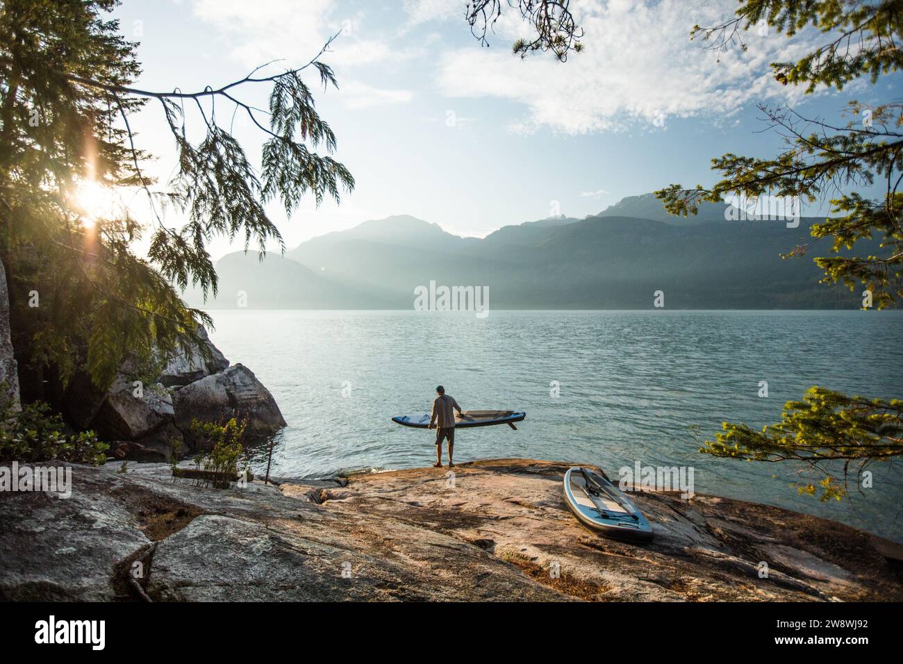 SUP paddle boarder getting ready for a morning paddle, Squamish Stock ...