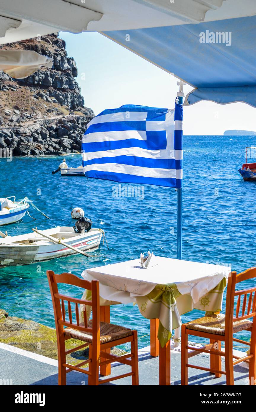 Table of a tavern in the port of Santorini Stock Photo - Alamy