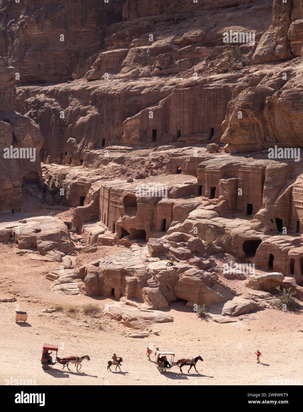 Horse carts and tourists walking around Petra Stock Photo - Alamy