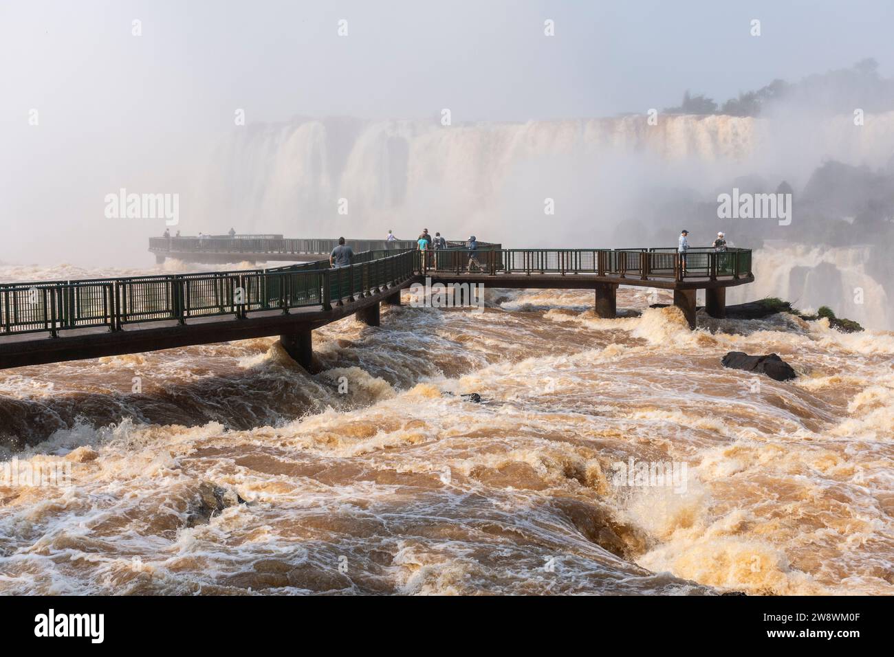 Beautiful view to walking path over strong waterfalls in Iguazu Stock ...