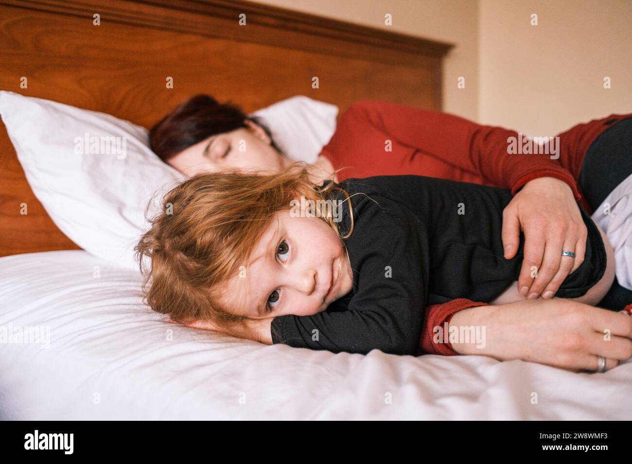 Mother and daughter resting together on a cozy bed Stock Photo - Alamy