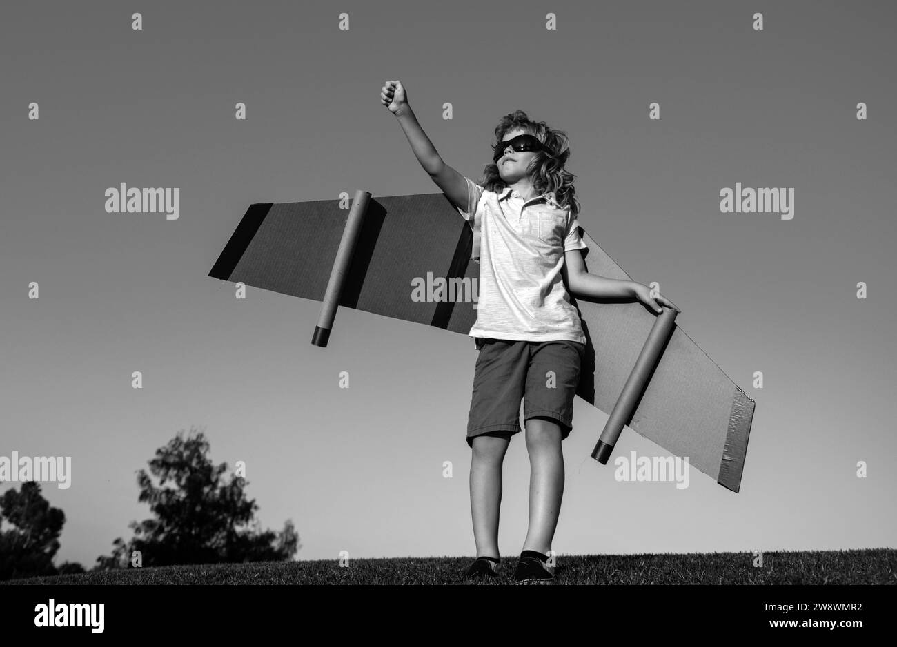 Kid superhero with jetpack. Child pilot play on summer day. Success ...