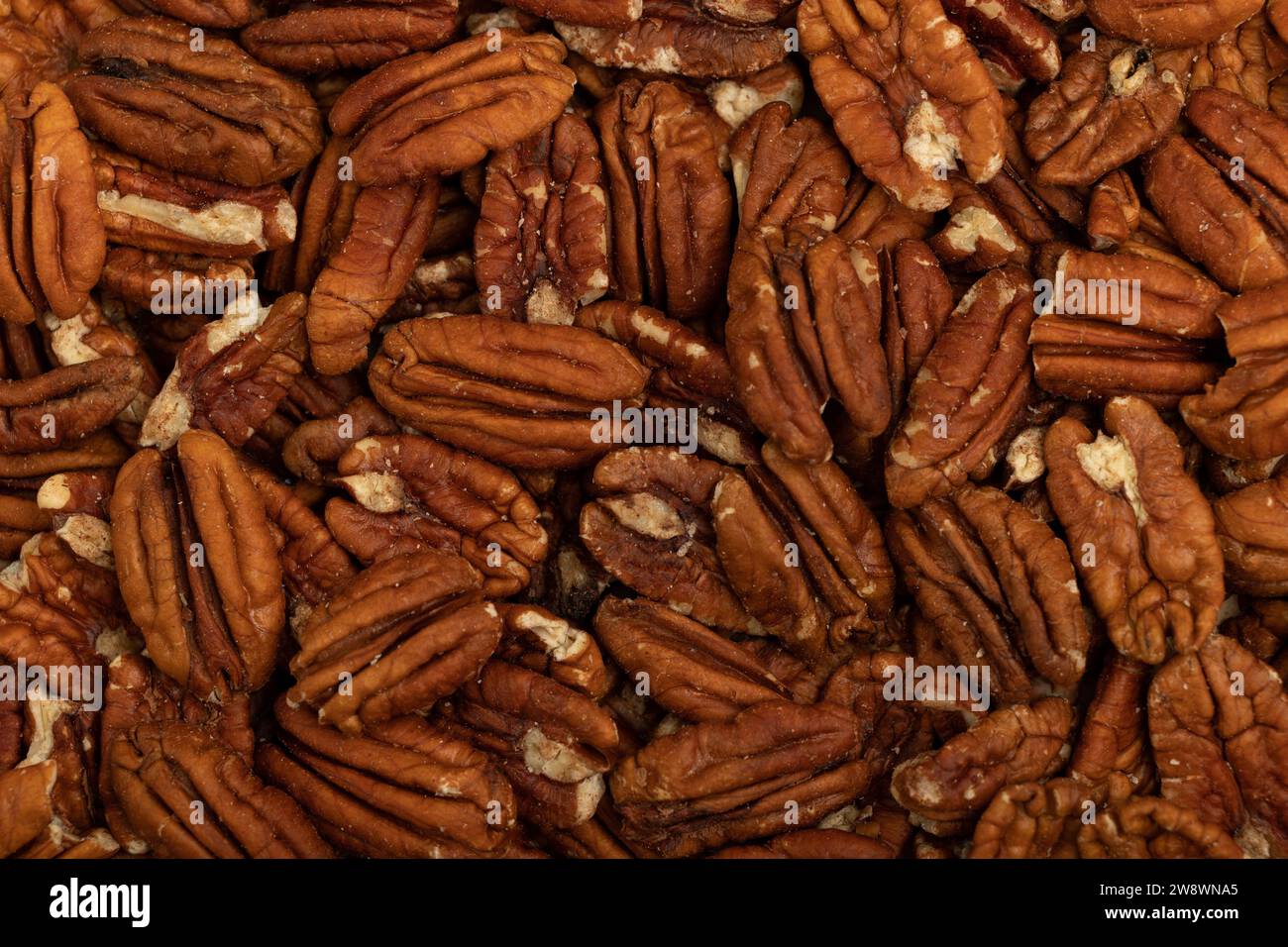 Top view of shelled pecans layered as a background Stock Photo - Alamy
