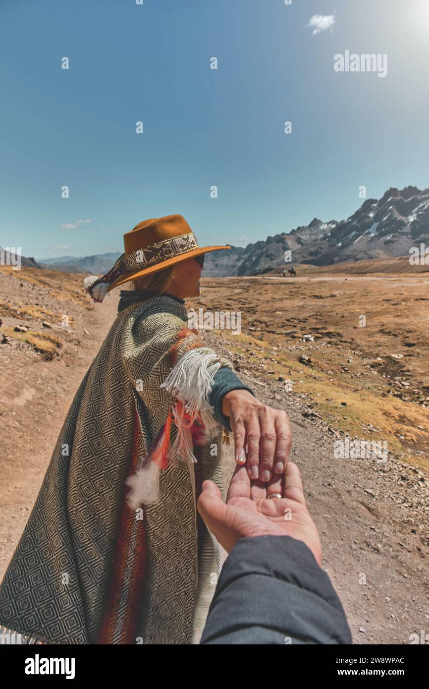 Closeup Young woman holding man hand while leading him on the rainbow ...