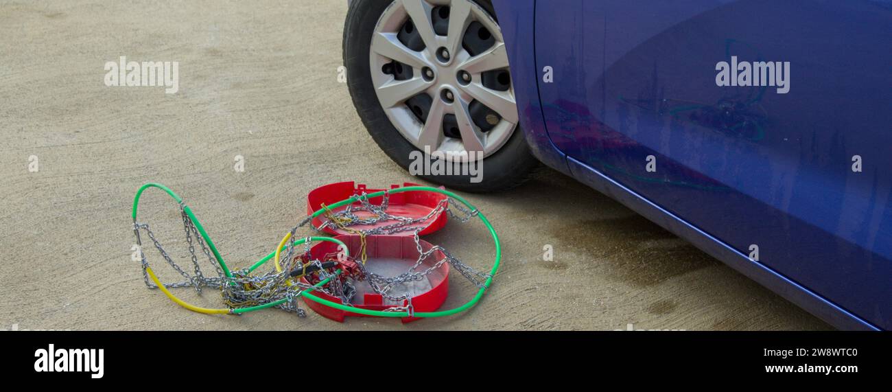 Image of a car with snow chains resting near the wheel. Difficulty in ...