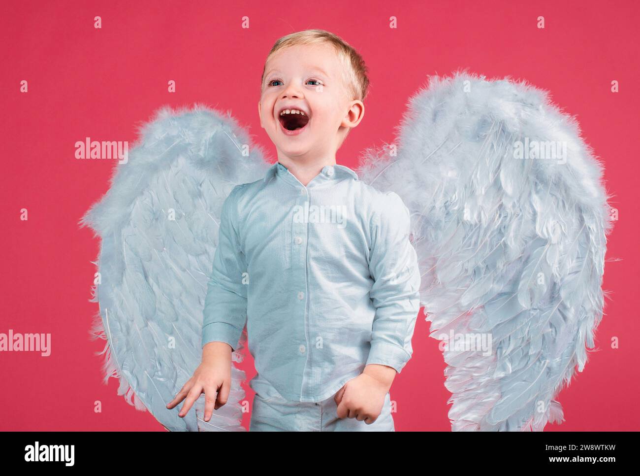 Portrait of happy smiling little curly blond Angel boy. Angelic child ...