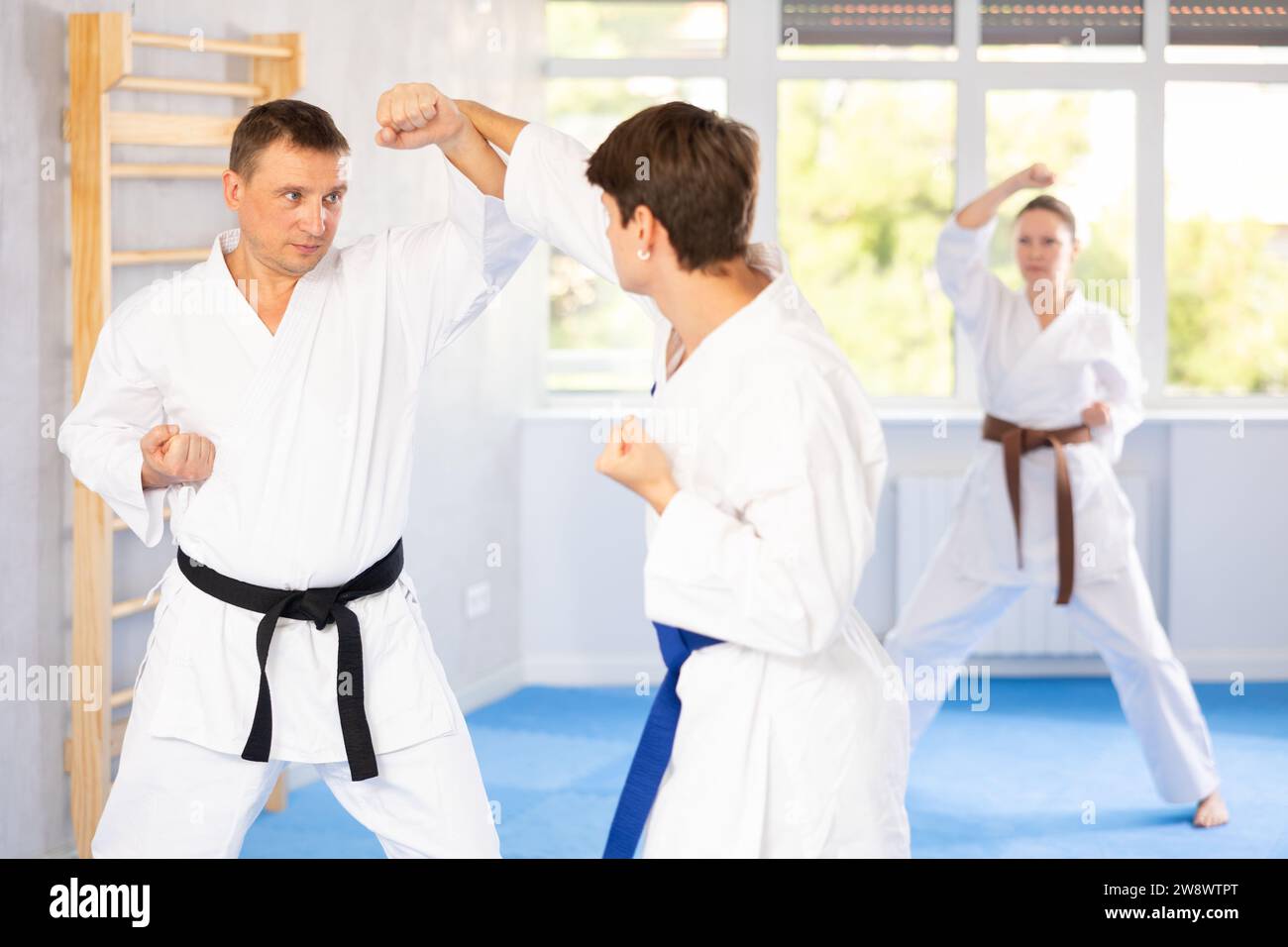 Two men are trained to perform basic defensive karate installations and ...