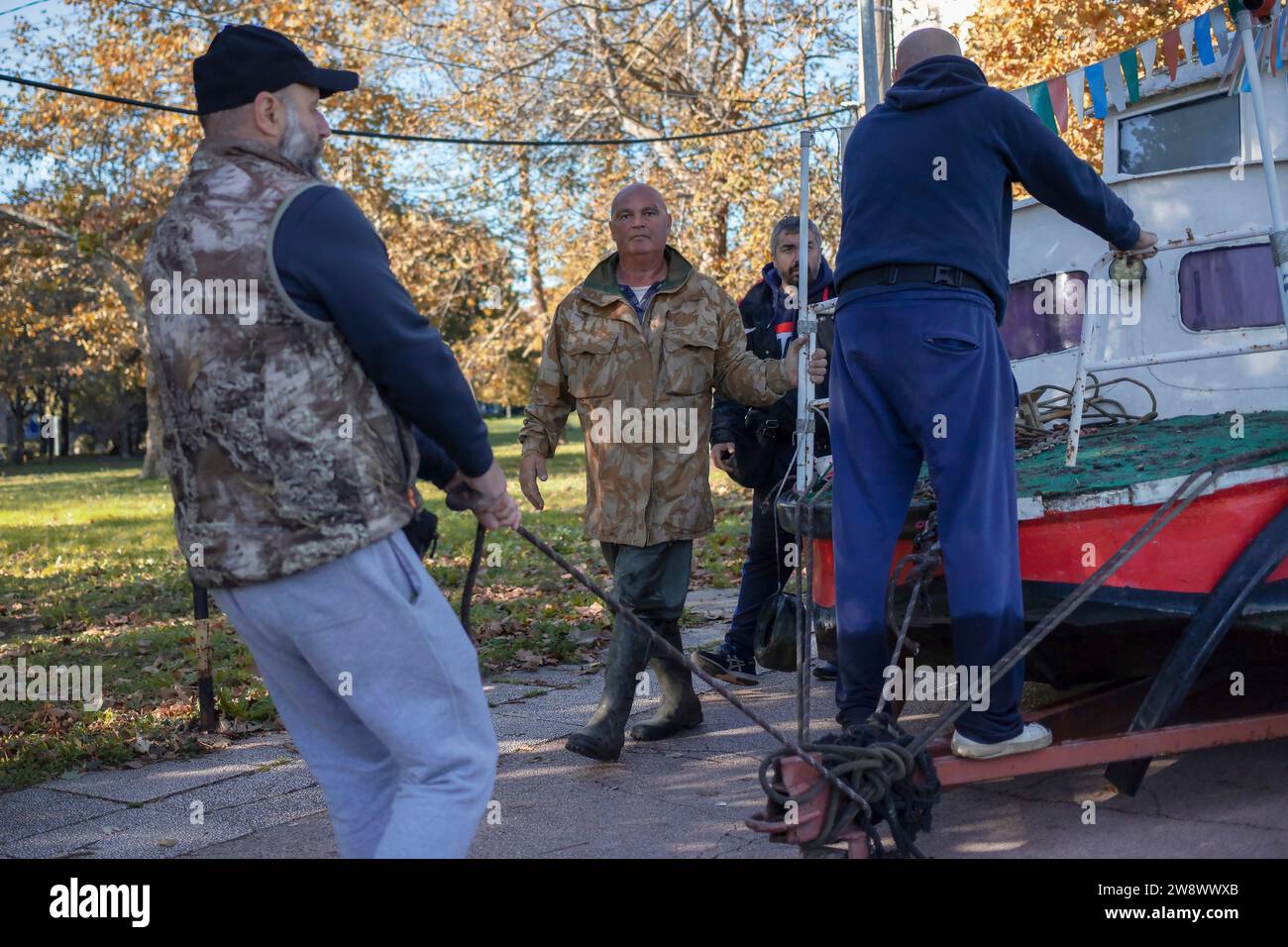 Belgrade, Serbia, Nov 12, 2023: A group of people pulling an old metal ...