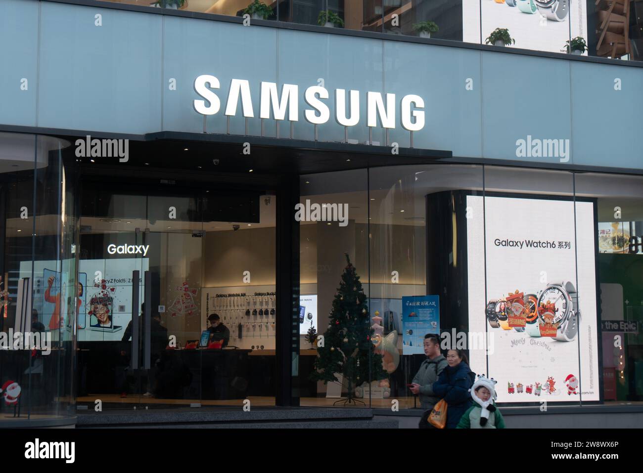 SHANGHAI, CHINA - DECEMBER 22, 2023 - People walk past a Samsung store ...