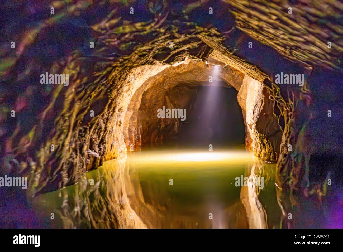 Interior of an underground river in Remouchamps caves illuminated with ...