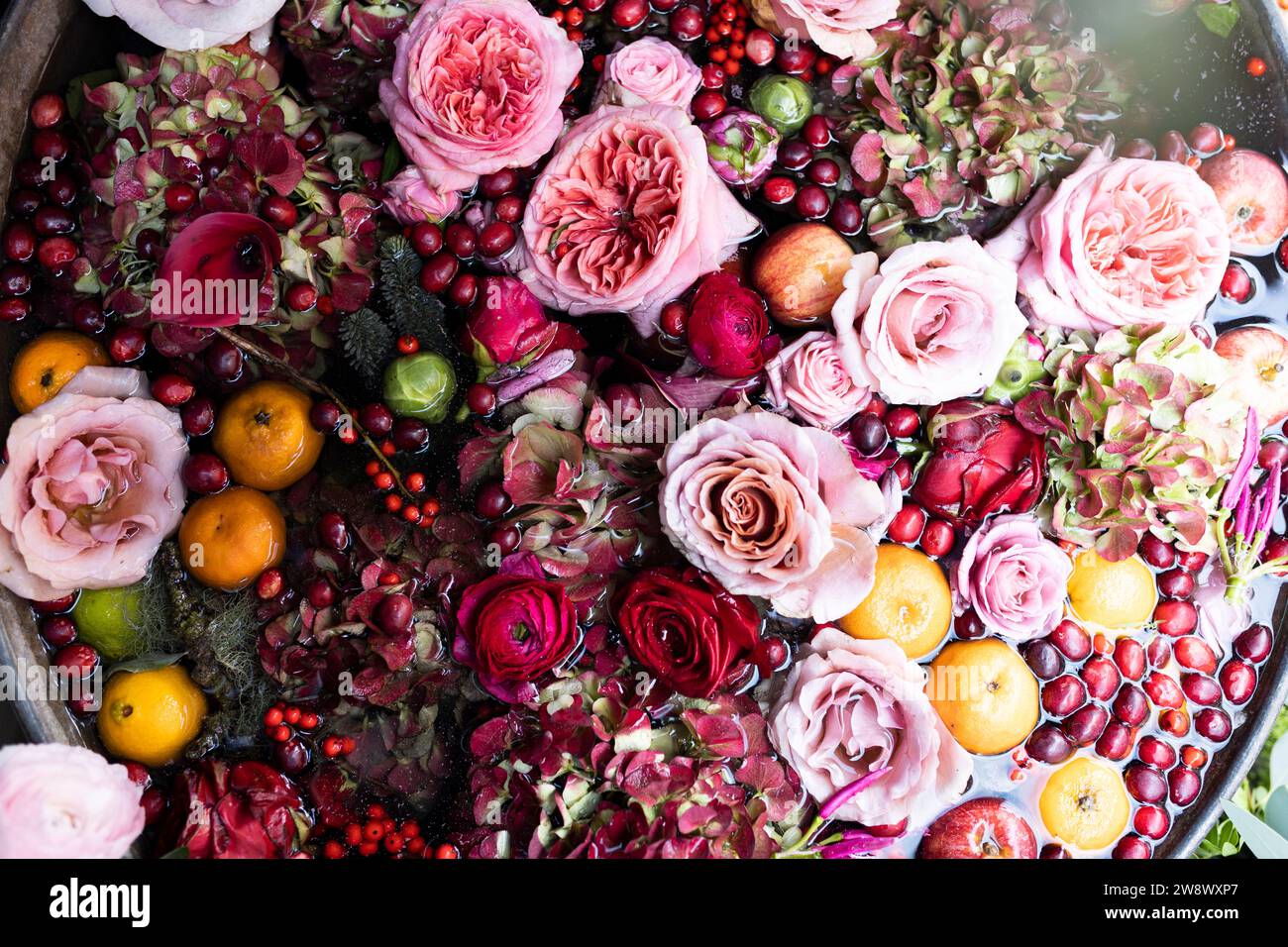 Red roses, hydrangea, reddish cranberries, chrysanthemums, tangerines ...