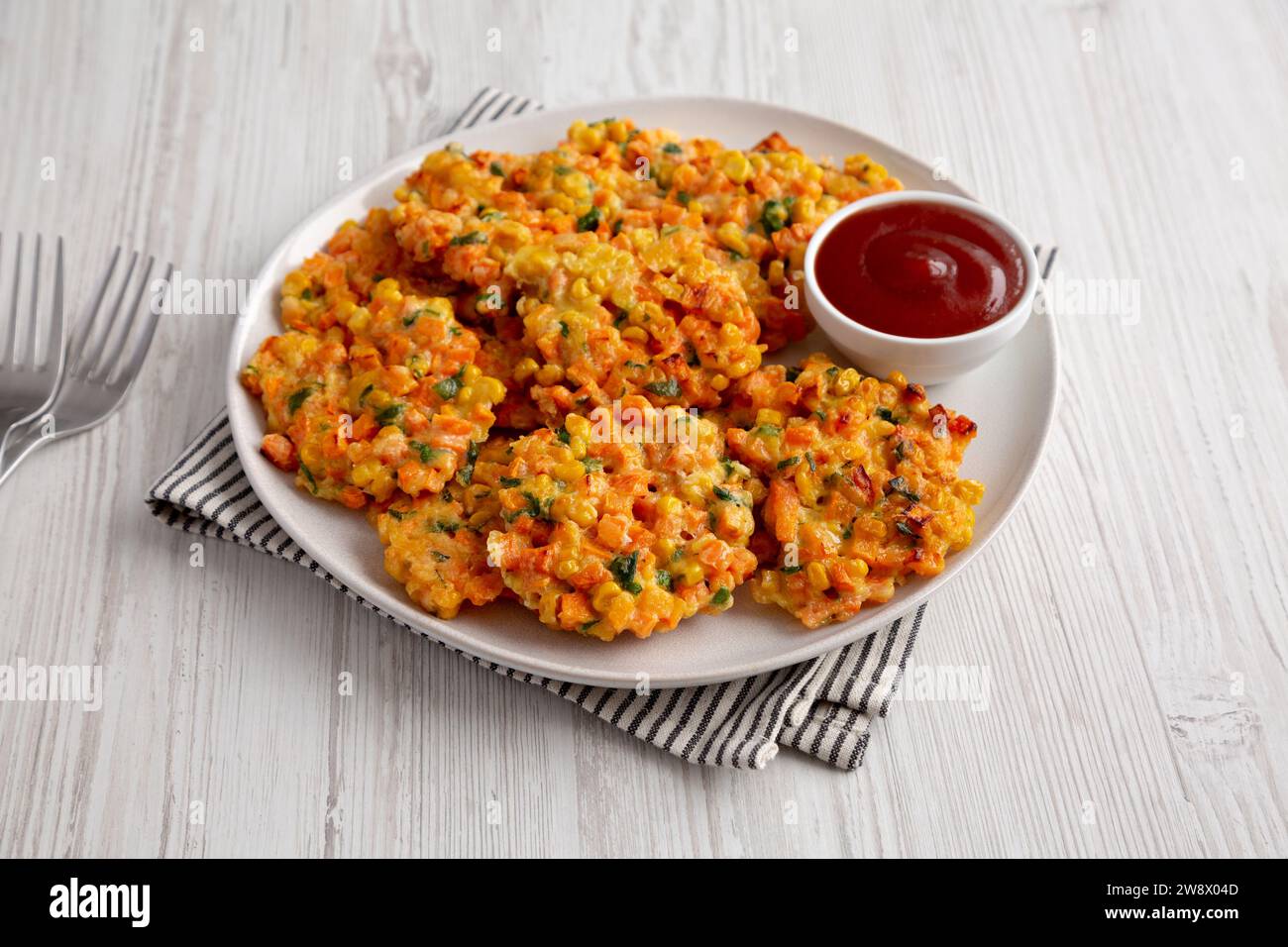 Homemade Carrot Corn Fritters with Ketchup on a Plate, side view Stock ...