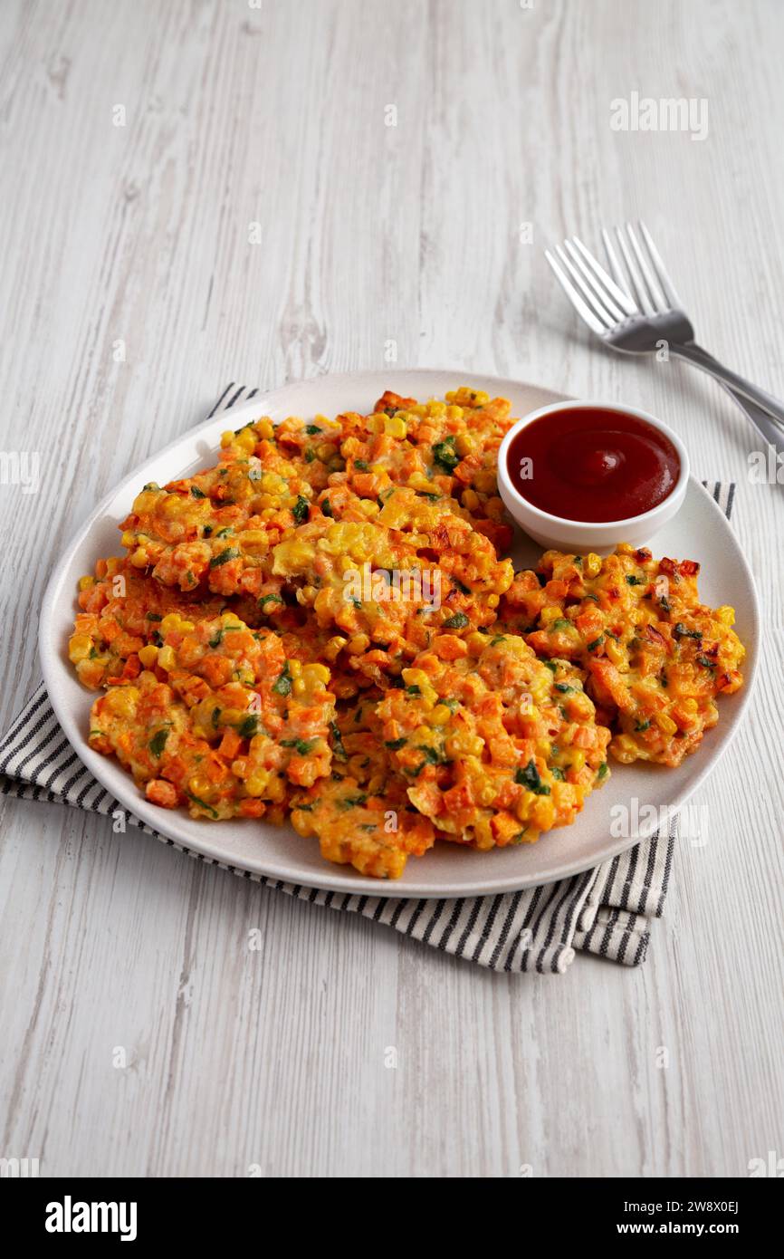 Homemade Carrot Corn Fritters with Ketchup on a Plate, side view Stock ...