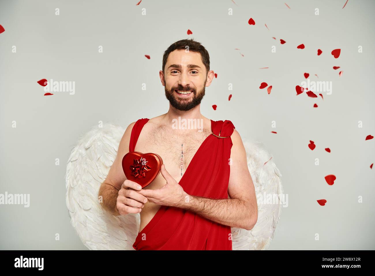 happy bearded man dressed as cupid with red hear-shaped st valentines ...