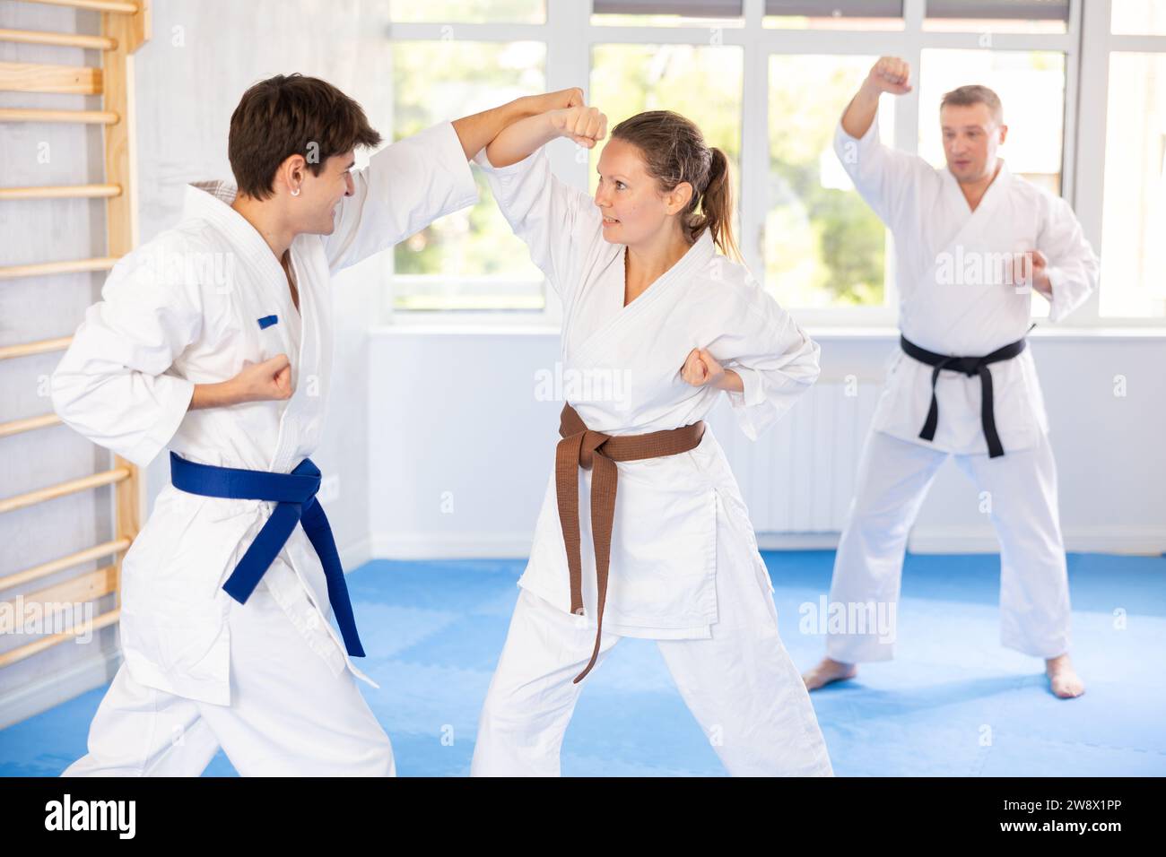 Man and woman train to perform basic defensive attacking actions during ...