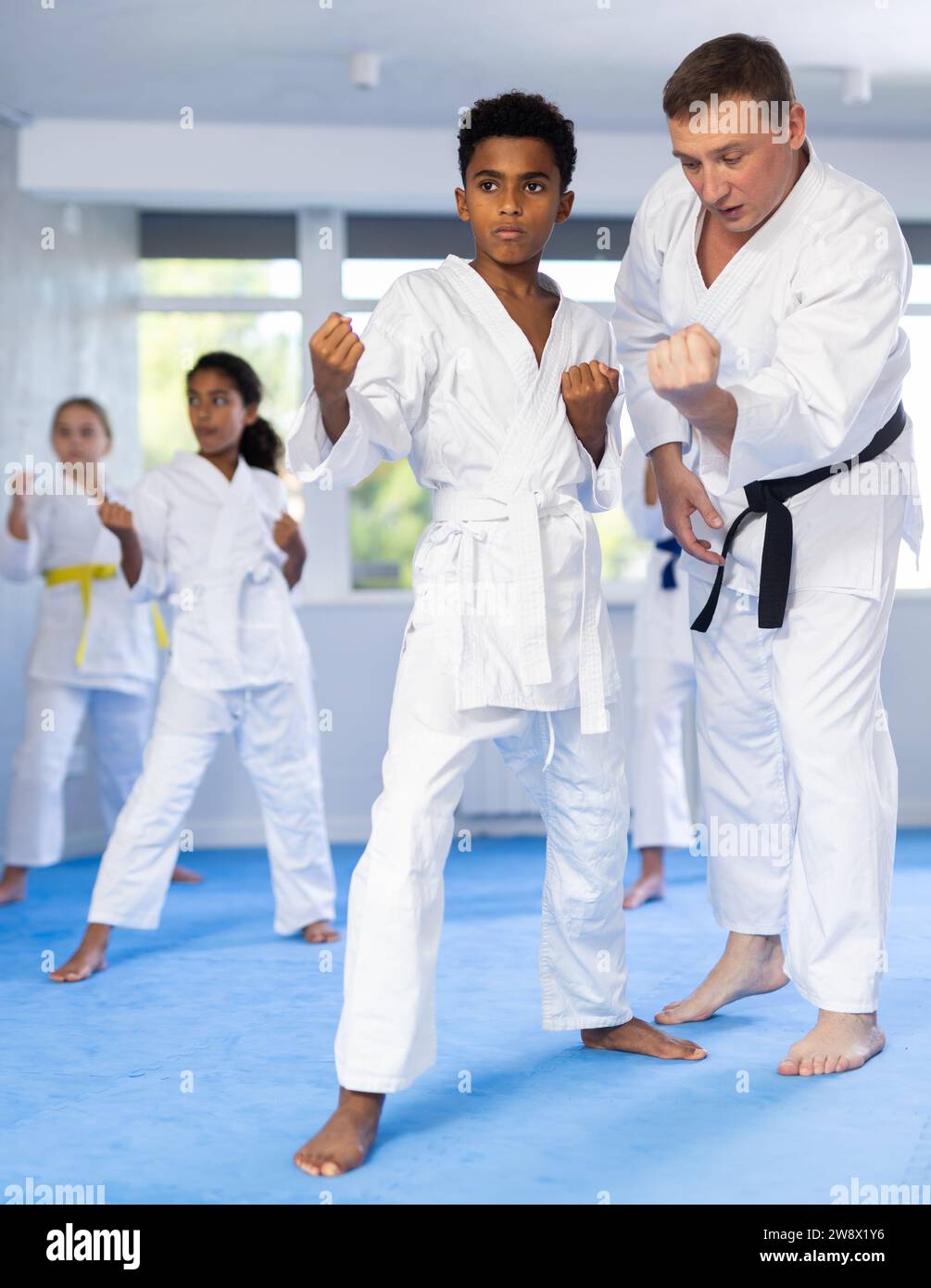 Children of different nationalities in kimono standing in fight stance ...