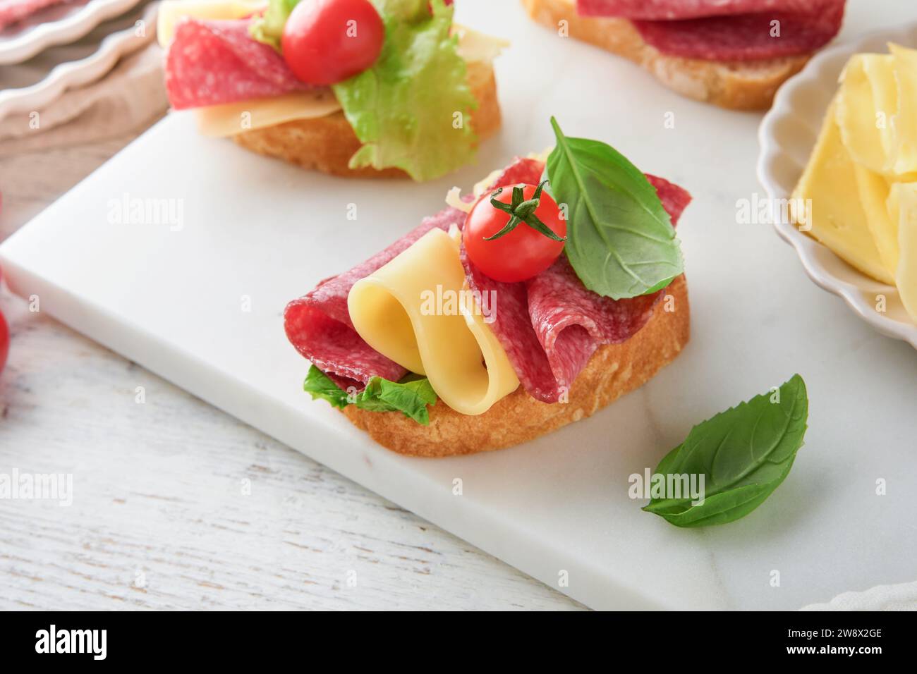 Salami sandwich. Delicious toasted sandwiches with slice salami, cheddar cheese lettuce and ...