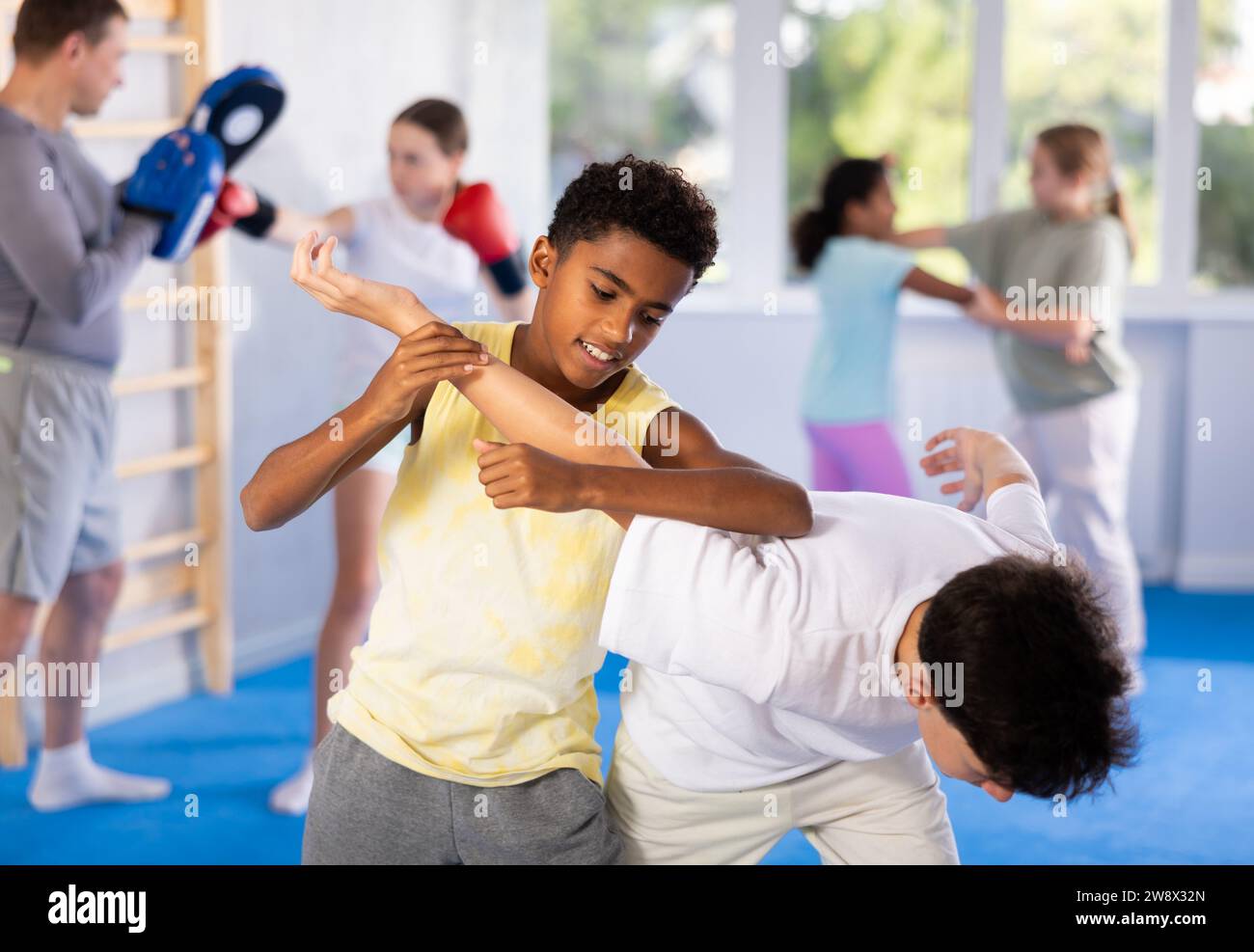 Two boys practicing self-defense techniques Stock Photo - Alamy