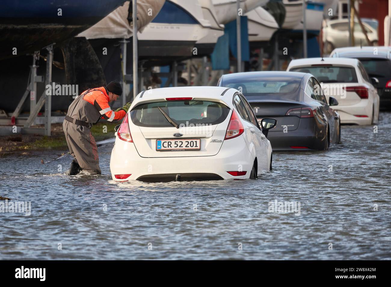 Cars stand in water on the Aalborg harbor front in North Jutland ...