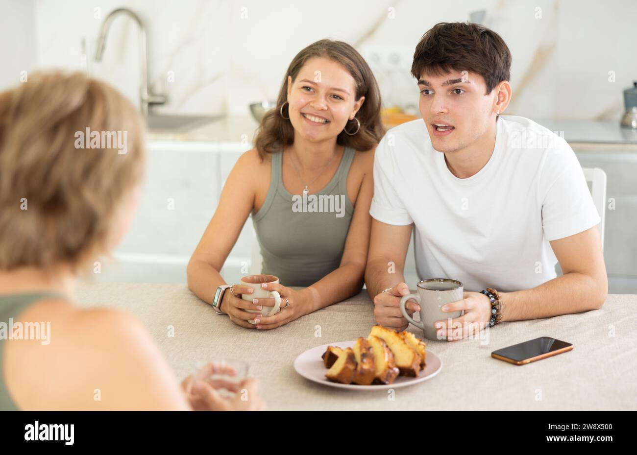 Young girl and guy have nice conversation with woman Stock Photo - Alamy