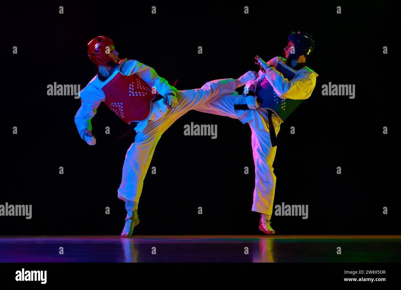 Competitive strong young men, taekwondo, karate athletes in motion ...