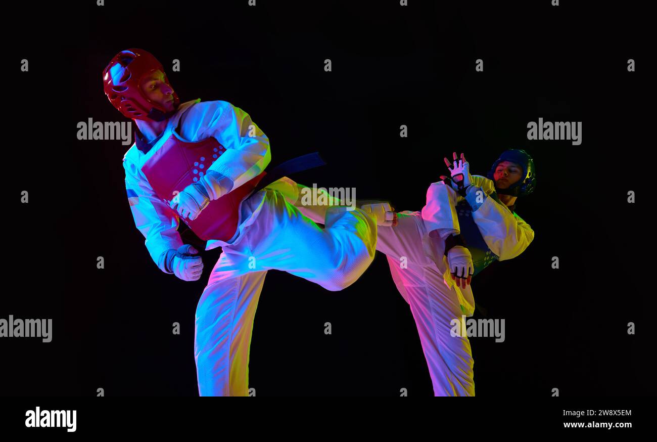 Competitive strong young men, taekwondo, karate athletes in motion ...