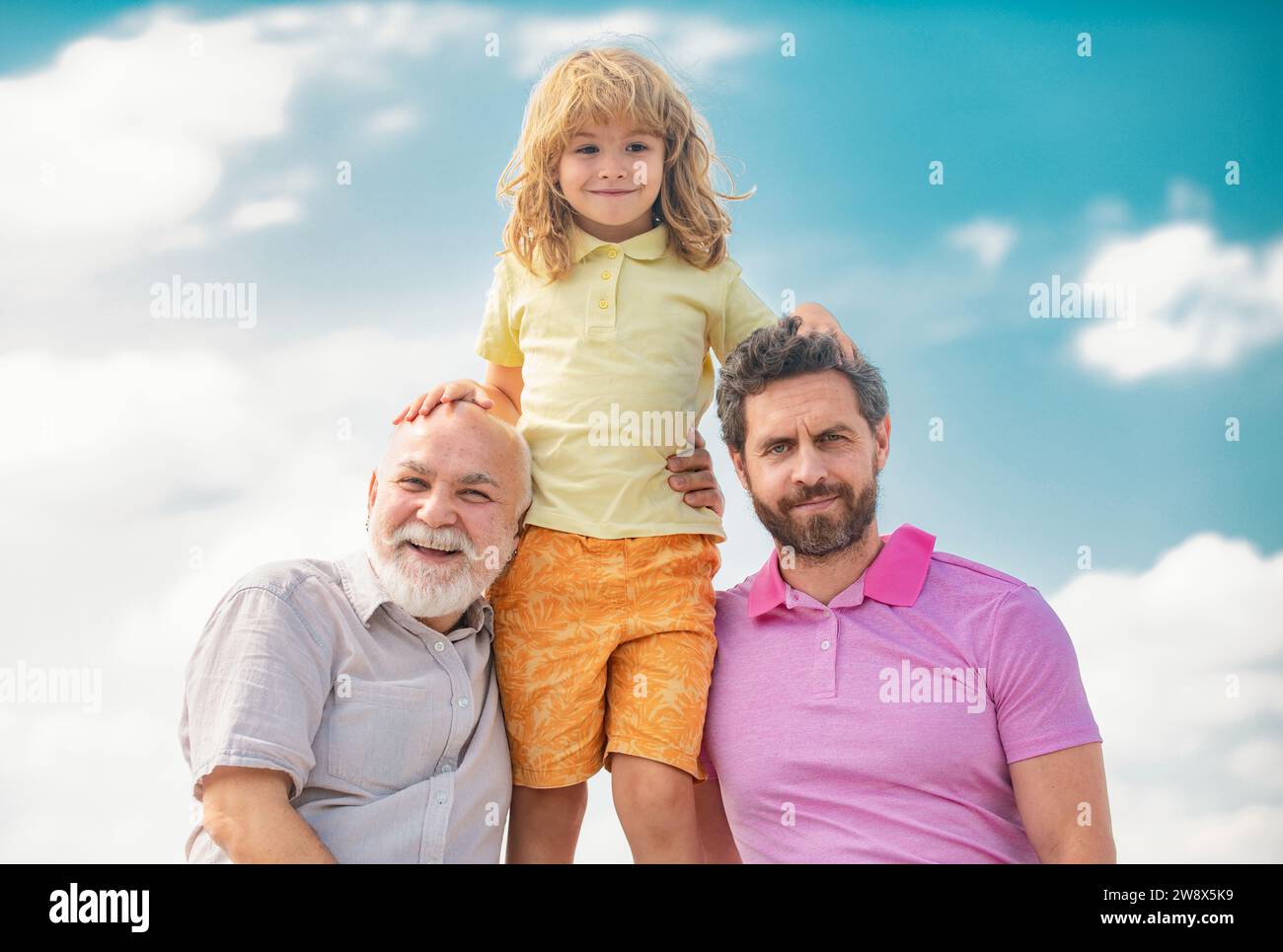 Portrait of grandfather father and funny son child outdoor on sky ...