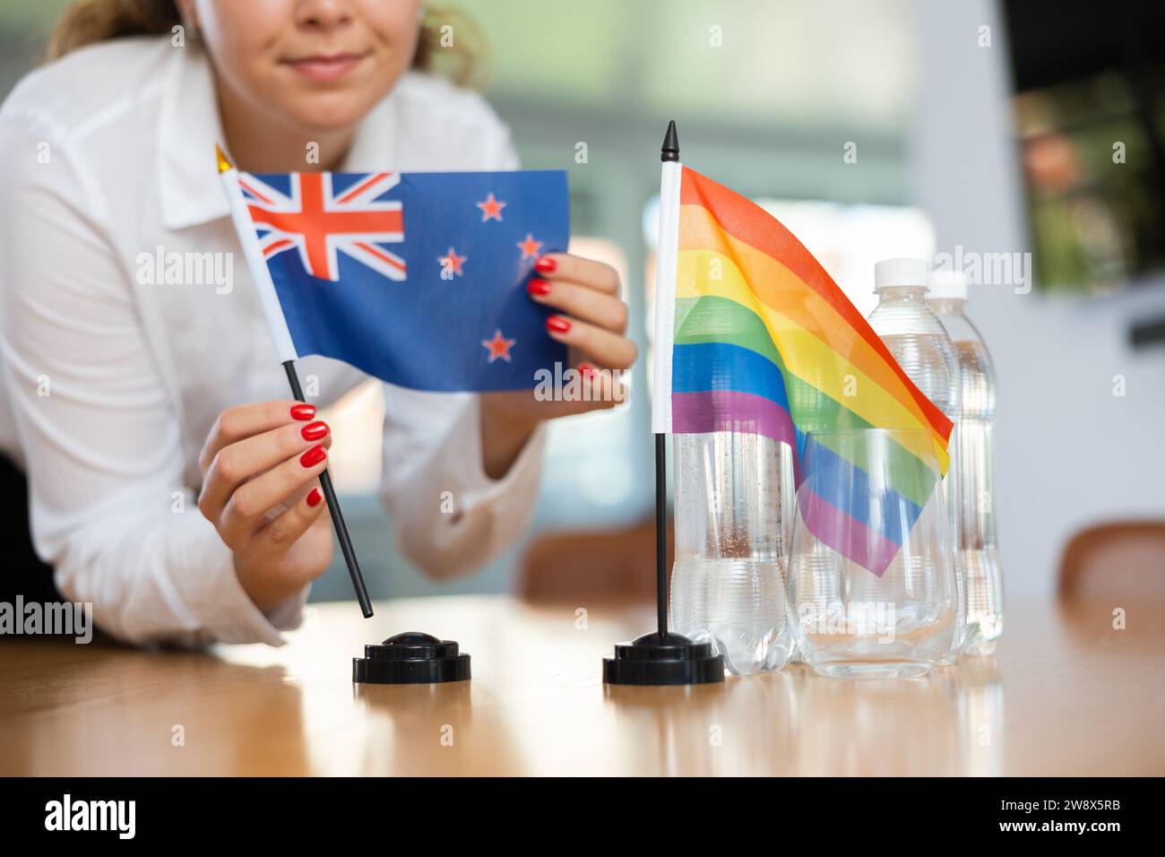 Unrecognizable girl sets midget flags of LGBT and Australia before ...
