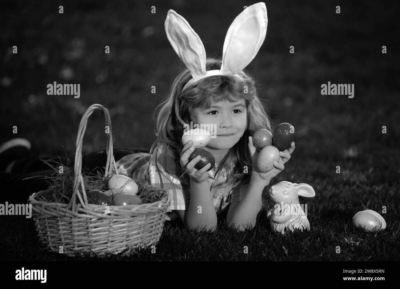 Child bunny boy with rabbit bunny ears. Child boy with easter eggs and ...