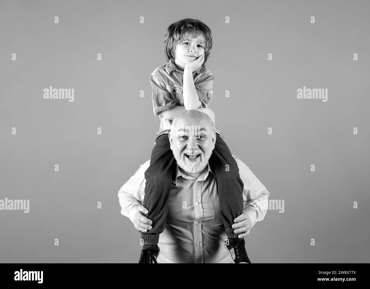 Grandson child and grandfather piggyback with funny face isolated on ...