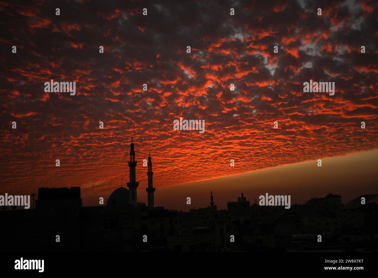 Rafah, Gaza. 21st Dec, 2023. The sky is illuminated red at sunset ...