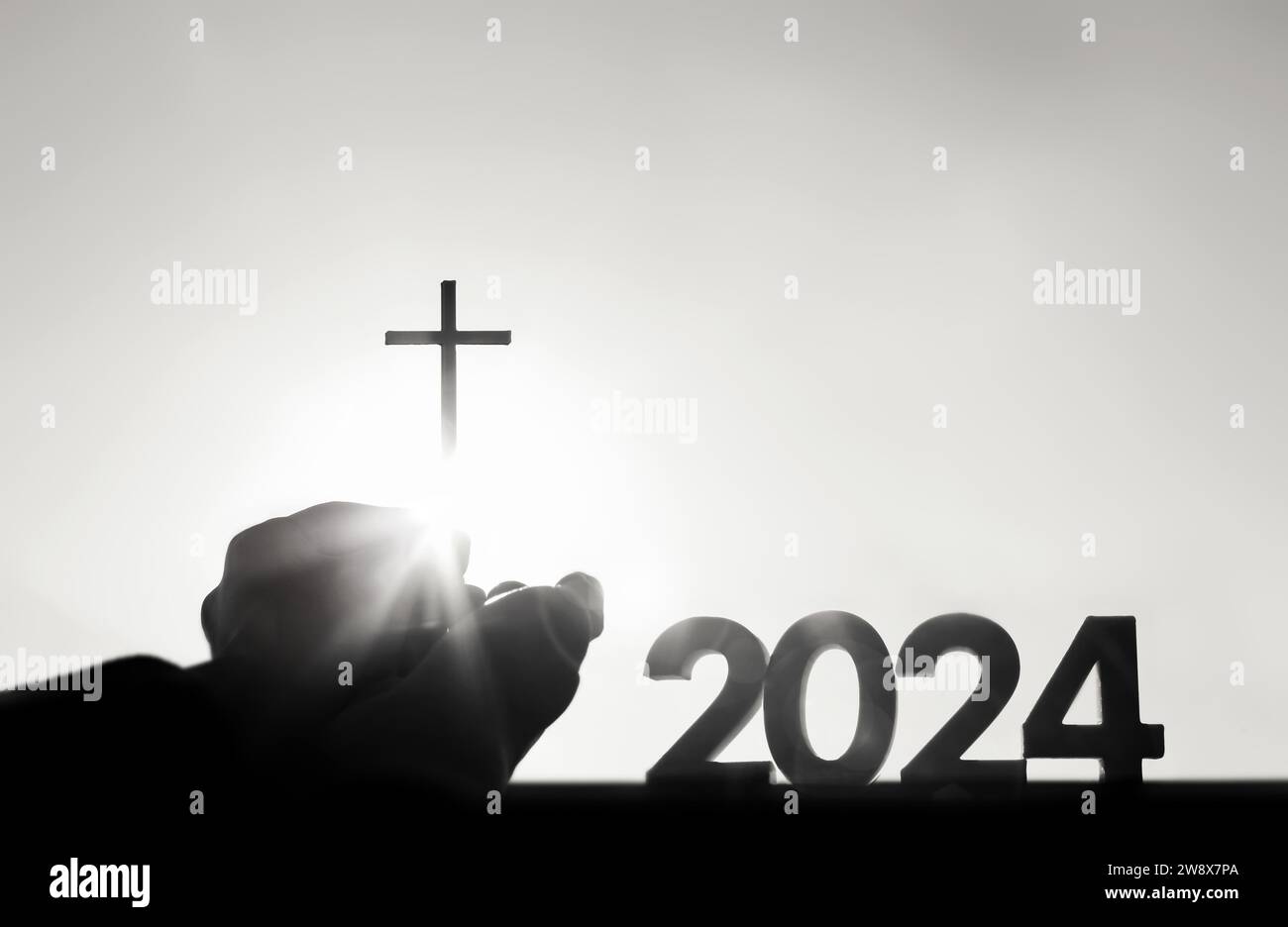 New Year 2024 Christians hold high the cross of Jesus Christ, symbolizing death and resurrection ...
